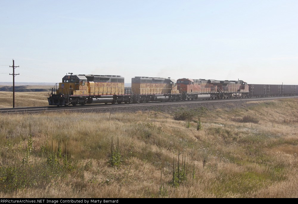Two UP and Two BNSF Units Pull Herzog Ballast Train West of Cheyenne